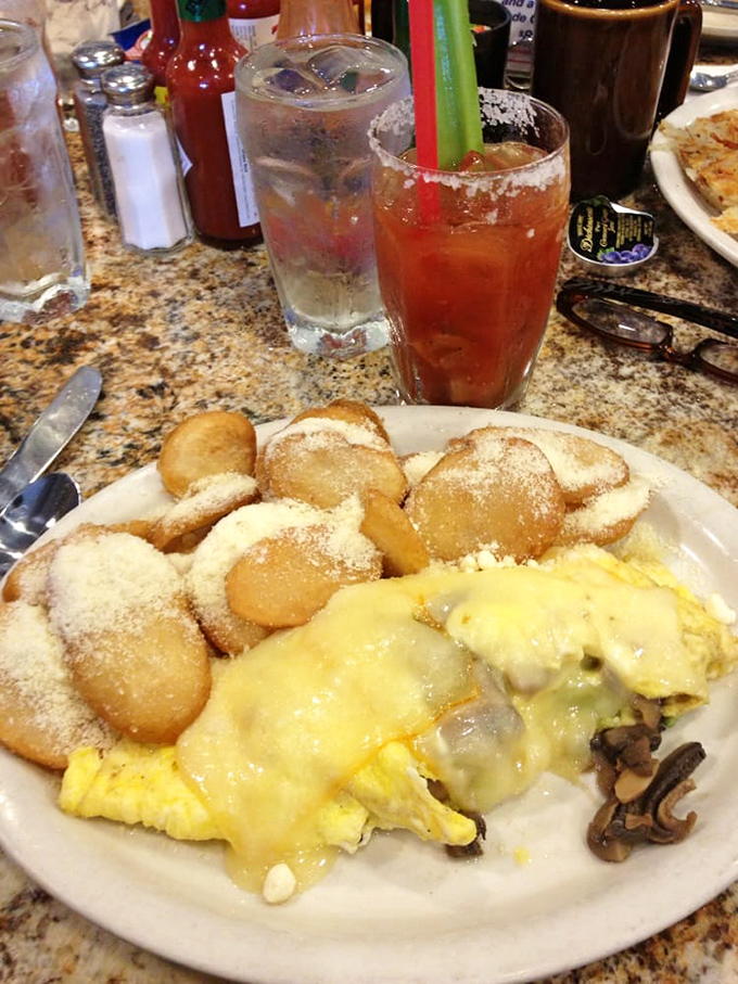 A cheese-blanketed omelet alongside perfectly round silver dollar pancakes – the breakfast equivalent of winning the lottery twice in one day.