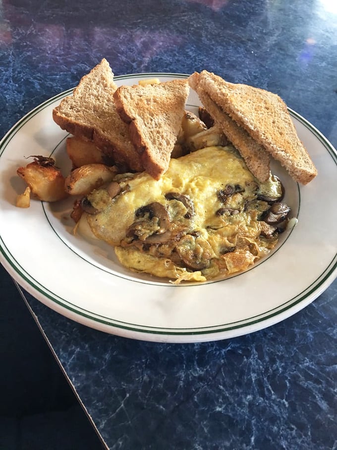 This mushroom and veggie omelet doesn't just satisfy hunger—it creates happiness. Paired with crispy potatoes and toast, it's the breakfast trifecta