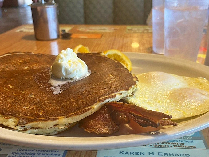 Golden pancakes with a pat of melting butter and crispy bacon—the breakfast equivalent of a warm hug on a plate.