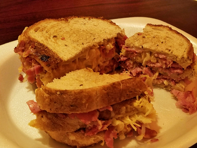 This isn't just a sandwich; it's a skyscraper of pastrami engineering that makes the Empire State Building look like amateur hour.
