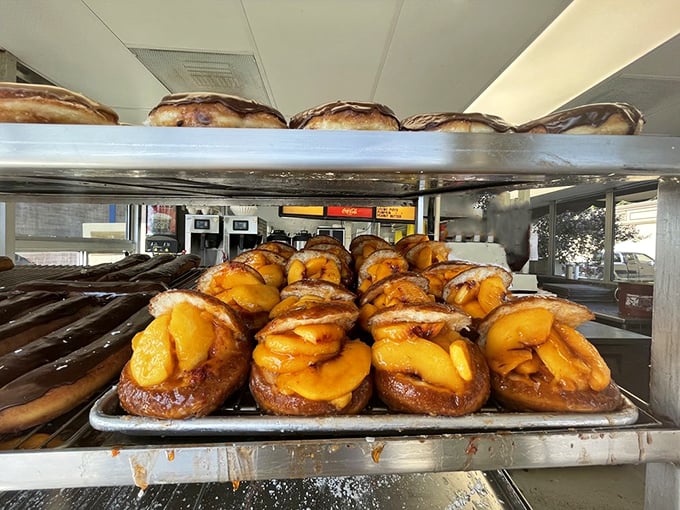 Summer sunshine captured in donut form. These peach-stuffed beauties make you understand why people drive across county lines at dawn.