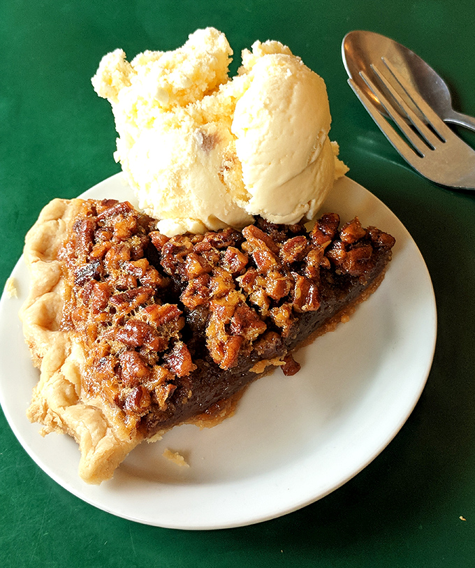 Pecan pie with a scoop of vanilla ice cream—the kind of dessert that makes you want to call your mother and apologize for ever complaining about anything.