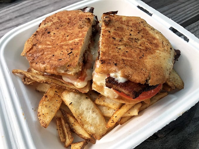 This sandwich doesn't just satisfy hunger – it solves problems. Golden-crisp exterior, melty interior, and flat fries that double as edible utensils.