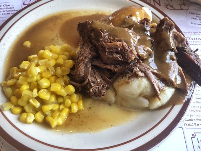 Pot roast nirvana! Tender beef swimming in gravy alongside those legendary mashed potatoes and sweet corn—a holy trinity of comfort that speaks directly to your soul.