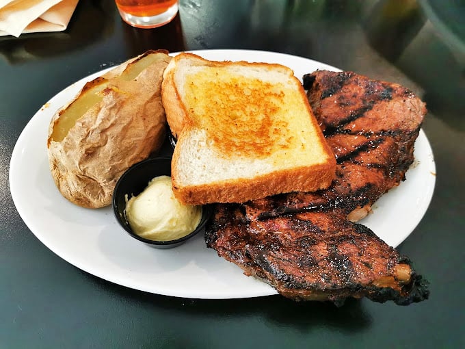 This isn't just a steak—it's a masterpiece with grill marks. The baked potato stands by like a loyal sidekick.