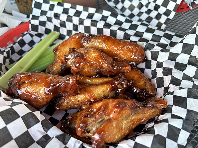 These wings didn't just fly—they soared through clouds of hickory smoke before landing gloriously on your table, glistening with sauce and possibility.