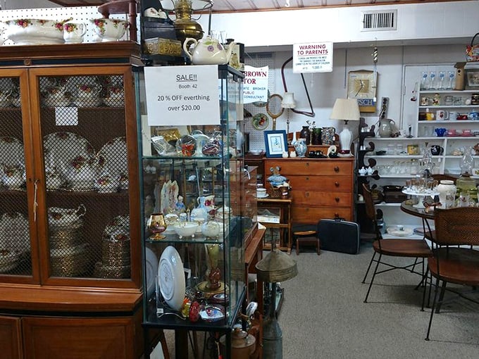 The vendor booths are like time capsules—this one mixing elegant china cabinets with treasures that survived countless Florida hurricane seasons.