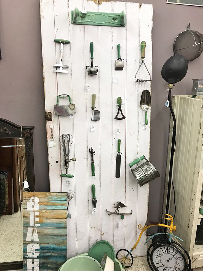 A clever display of vintage kitchen utensils with jadeite green handles transforms everyday tools into an artistic statement. Julia Child would approve.