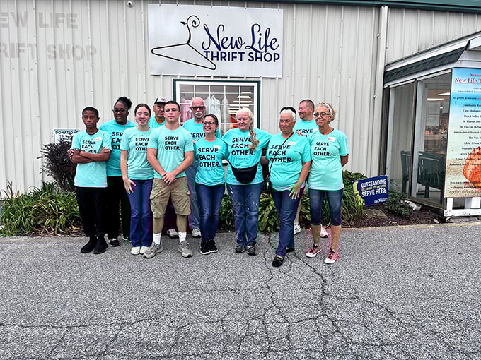 The real treasures of any thrift shop: the dedicated volunteers whose "Serve Each Other" shirts perfectly capture the spirit of community.