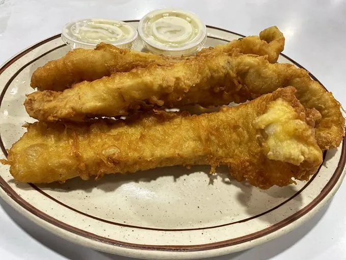 Golden-battered walleye that shatters with each bite, served with dipping sauces that make you wonder why you'd eat fish any other way.