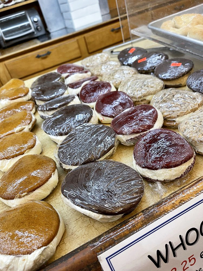 Whoopie pies lined up like edible hockey pucks of joy—some chocolate, some golden, all waiting to be drafted into your dessert lineup.