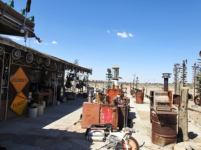 The workshop area reveals the organized chaos behind the magic, where "FLOODED" signs ironically stand in one of America's driest landscapes.