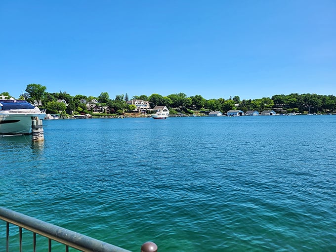 Charlevoix's waterfront beckons with blue waters and boats bobbing gently – pure Michigan magic captured in one frame.