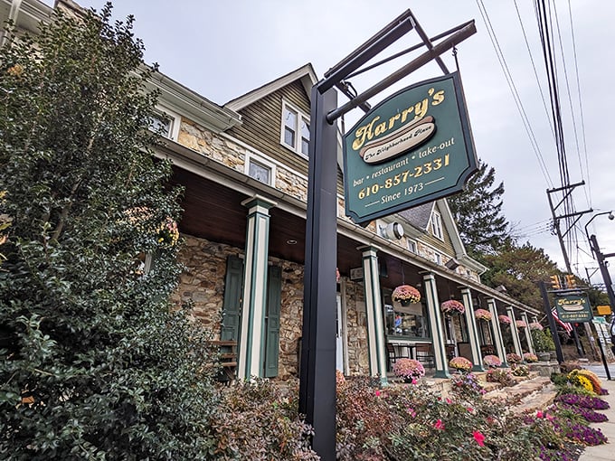 Harry's stone facade and hanging sign don't just say "restaurant" – they whisper "come inside, we've been perfecting hot dogs while others were still figuring out fire."