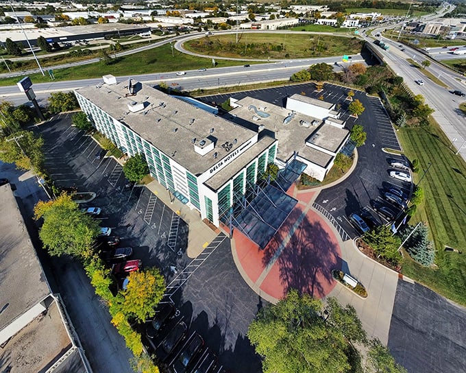 Menomonee Falls from above – a patchwork of colorful rooftops nestled between green hills and blue waters.