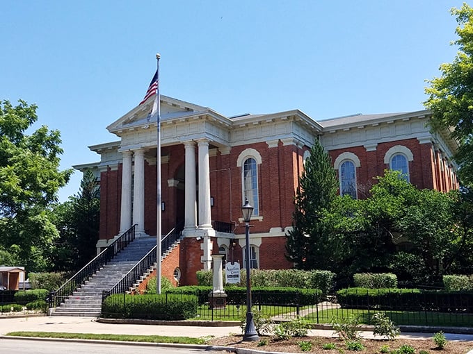 The classic red brick courthouse in Ottawa stands proudly against a cloudless sky – small-town grandeur at its finest.