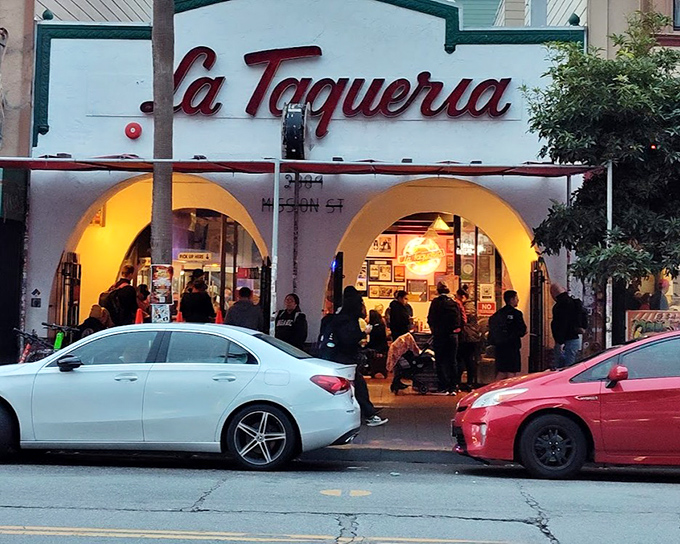 The evening crowd at La Taqueria isn't waiting for nightclub entry – they're lining up for something far more satisfying.