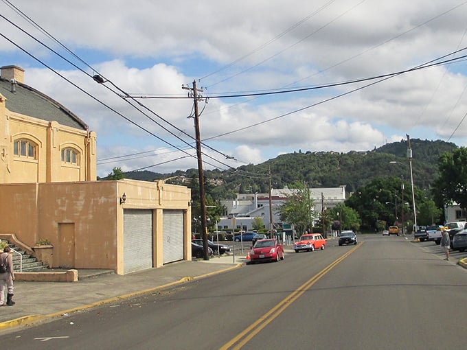 "Uphill both ways, as our grandparents would say! This street scene has that perfect small-town vibe where everyone probably knows your coffee order."