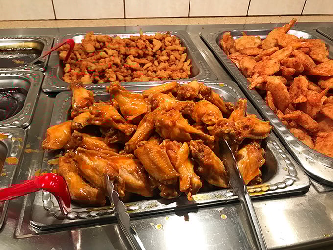 Buffalo wings glistening with sauce next to golden fried delights—proof that buffets can be about quality, not just quantity. A trifecta of crispy, tender, and saucy.
