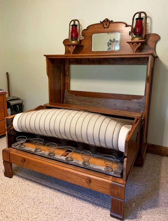 Not your average Murphy bed—this oak masterpiece with oil lamps and intricate detailing makes modern furniture look like it's not even trying.