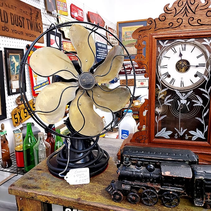 An antique fan sits beside a vintage clock and toy train—the holy trinity of nostalgia that makes grown men suddenly remember their childhood bedrooms.