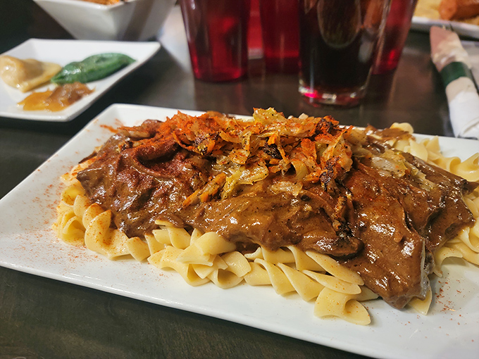 Tender pot roast over egg noodles with caramelized onions—the kind of dish that makes you want to kiss the chef and adopt their family.