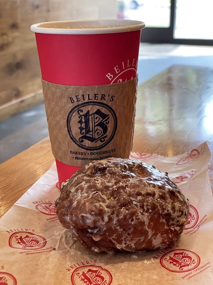 The dynamic duo: a glistening apple fritter and steaming coffee. Name a more iconic breakfast partnership—I'll wait.