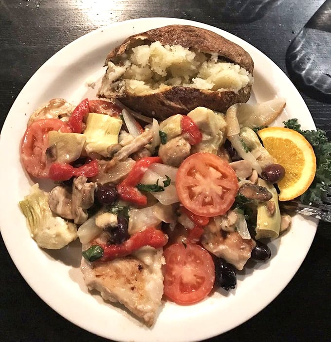 A Mediterranean vacation on a plate—chicken nestled among colorful vegetables and tomatoes, proving that healthy eating doesn't have to be a punishment.