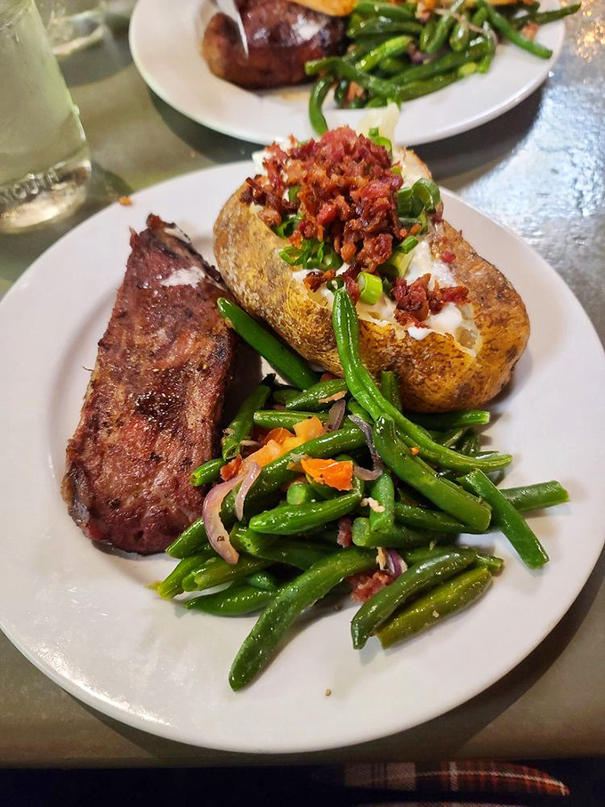 The loaded baked potato isn't just a side dish—it's practically its own zip code. That bacon topping isn't being subtle about its intentions to derail your healthy eating plans.