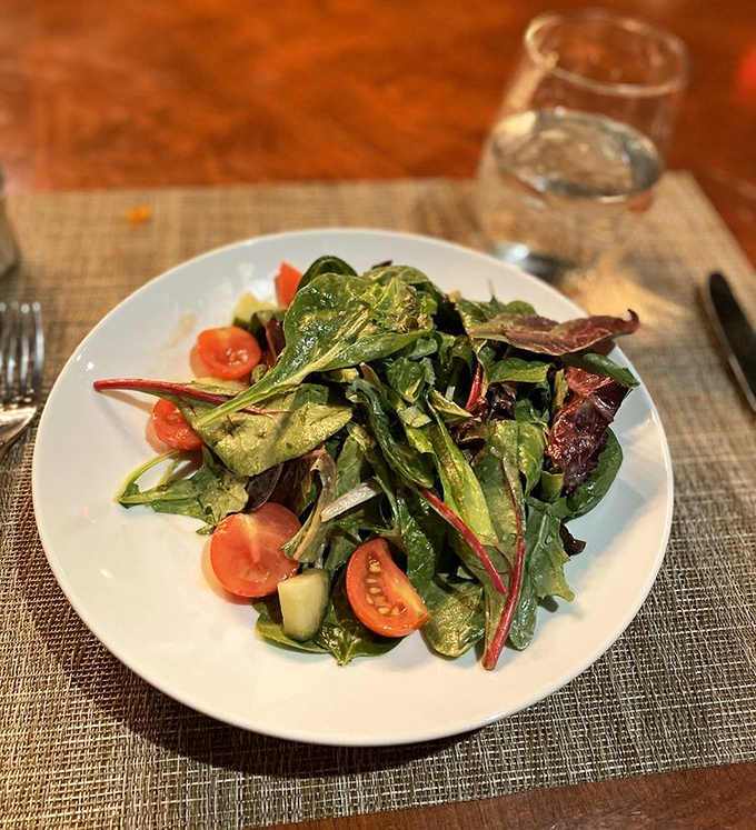 Fresh greens dance with ruby-red tomatoes in this vibrant salad—proof that sometimes the simplest combinations create the most memorable flavors.