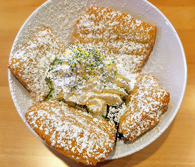 Powdered sugar isn't just a topping here—it's practically a food group. These beignets are what clouds wish they tasted like.
