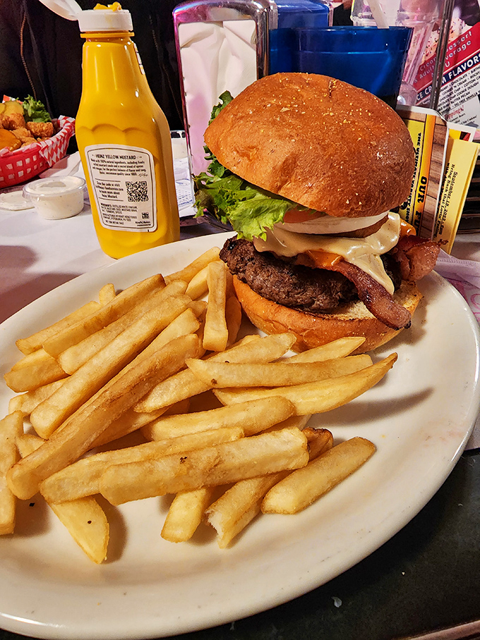 A burger that requires a game plan before the first bite. That stack isn't just lunch—it's an engineering marvel with fries.