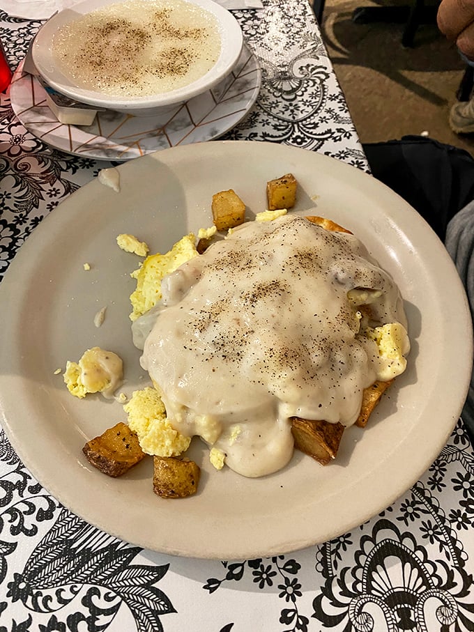 Biscuits drowning in creamy sausage gravy – because some mornings require this level of indulgent breakfast therapy.