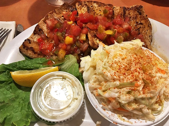 Blackened mahi-mahi topped with fresh salsa is the Florida equivalent of hitting the culinary lottery—especially with that perfectly spiced coleslaw riding shotgun.