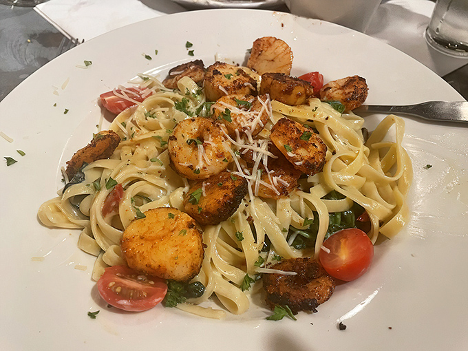 Blackened shrimp dance atop fettuccine like performers on a delicious stage, proving that Naples knows its seafood as well as its steaks.