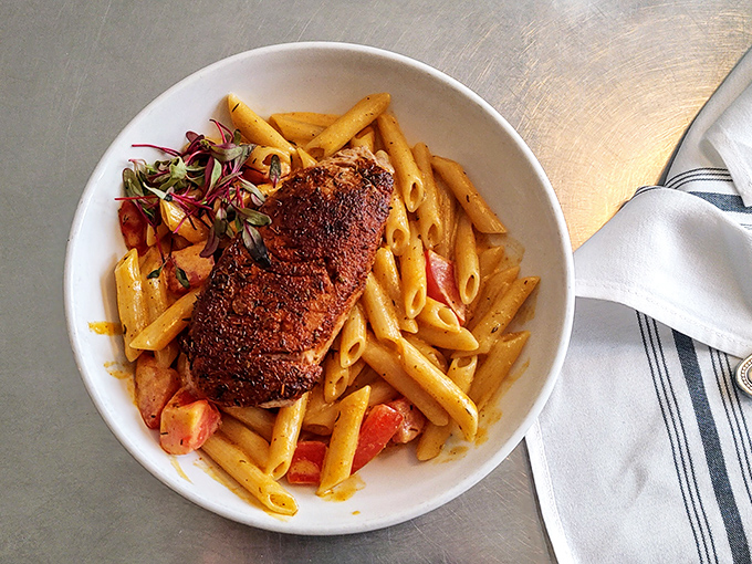 Blackened tuna atop pasta isn't just dinner—it's evidence that someone in this kitchen understands the perfect marriage of land and sea.