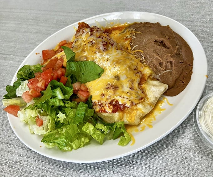 Mexico meets the Keys in this cheese-blanketed masterpiece. With fresh lettuce, diced tomatoes, and refried beans that would make abuela proud.