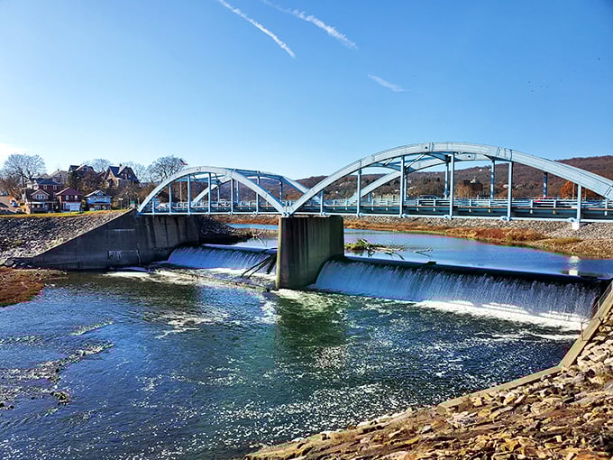 Not just any bridge—a gateway between worlds. The water below rushes forward while the structure above connects communities that time nearly forgot.