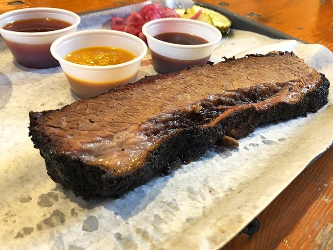 Behold the brisket—dark bark on the outside, tender perfection inside. Those three sauce options are like choosing between your favorite children.