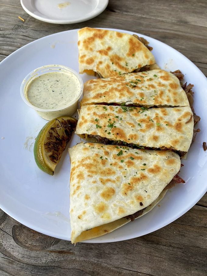 Barbecue innovation at its finest—a quesadilla that marries smoky brisket with melty cheese in a union blessed by the food gods.