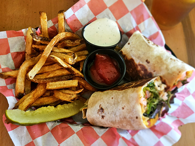 The humble wrap, elevated to art form. Hand-cut fries, tangy sauce, and that pickle spear standing guard like it knows something you don't.