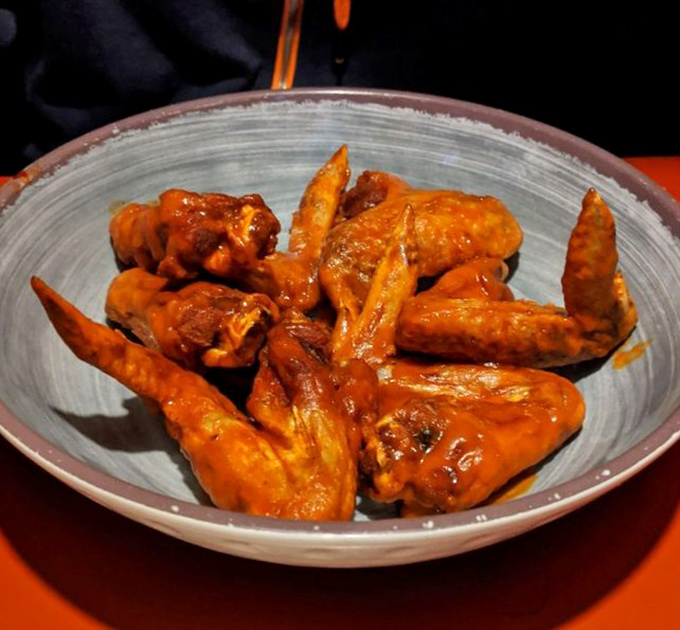 Buffalo wings that don't mess around—crispy, saucy, and unapologetically messy. Your fingers will be orange, your mouth will be happy, and napkins will be essential.