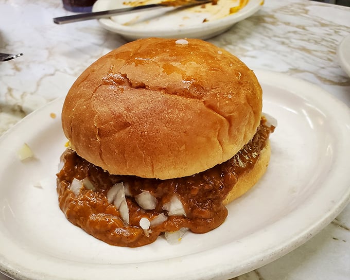 Chili burger nirvana! A soft bun barely containing the perfect ratio of beef, chili, and onions—a delicious mess worth every napkin you'll need.