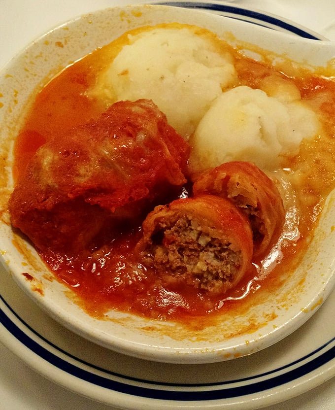 The legendary cabbage rolls—tender cabbage embracing seasoned meat and rice, swimming in a tomato sauce that's been perfecting itself since Elvis was king.