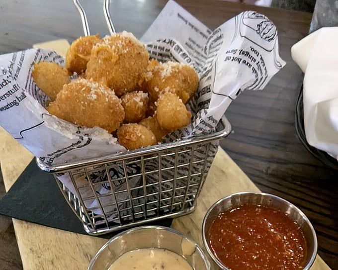 These golden cheese curds aren't just appetizers—they're little nuggets of joy that squeak between your teeth like edible stress relievers.