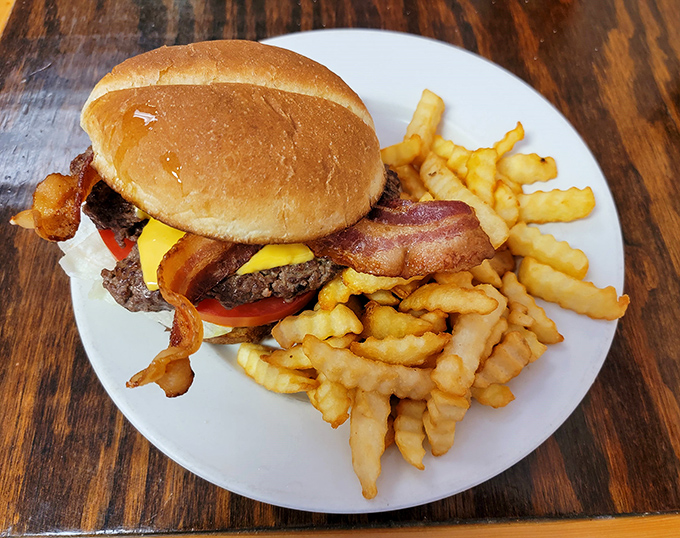 Behold the burger that launched a thousand road trips—hand-patted, perfectly melted cheese, and those crinkle-cut fries that somehow taste better than your childhood memories.