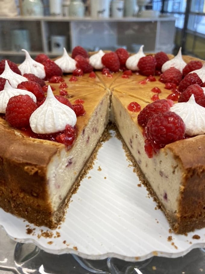 This raspberry-topped cheesecake isn't just a dessert, it's an event – complete with meringue kisses standing guard around the perimeter.
