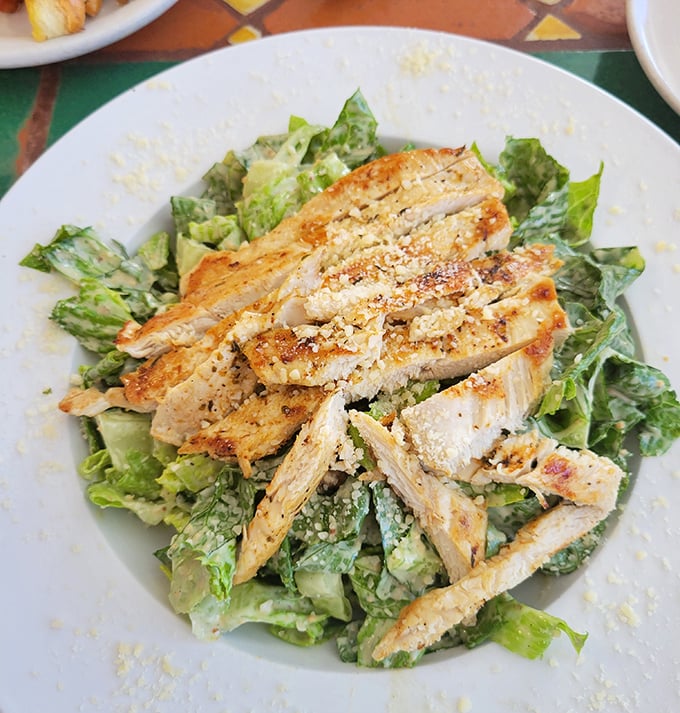 A chicken Caesar salad that actually makes you feel virtuous while indulging—crisp romaine and seasoned chicken playing perfectly together like Sinatra and Bennett.