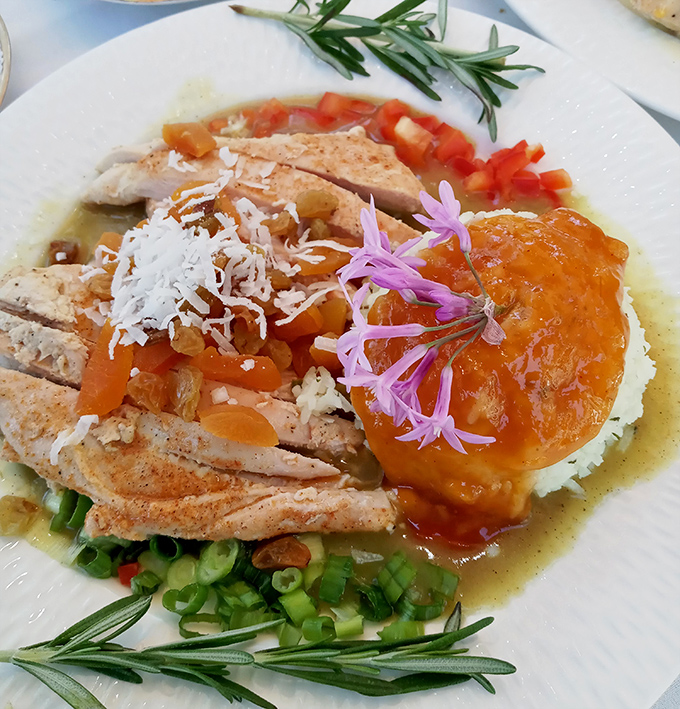 Chicken curry that doesn't hold back on flavor or presentation. Those edible flowers aren't just pretty faces—they're part of the experience.