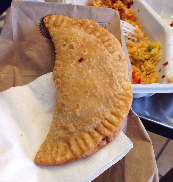 Golden, crispy, and filled with savory goodness—this empanada isn't just street food, it's street poetry in pastry form.